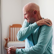 Home, senior man and shoulder pain with tension, bedroom and retirement ...