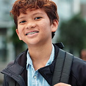 Outside, boy student and face in school for education, learning and ...
