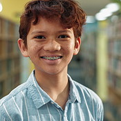 Braces, face and school with boy in library for child development ...