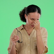 Creative woman, eye strain and pain on green screen, studio and stress ...