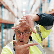 Face, hands and frame with man in warehouse, funny and capture with ...