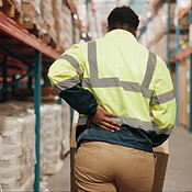 Logistics, boxes and man in warehouse with back pain, injury or ...