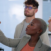 Business people, coding and discussion with whiteboard for planning ...