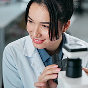Scientist, woman and microscope with computer in laboratory for medical ...