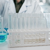 Hands, test tube and dropper in lab with scientist, container and ...