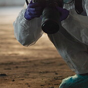 Forensic, marker and photographer at crime scene with camera for ...