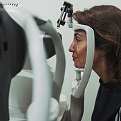 Woman, optometry and eye exam with machine in hospital, vision ...