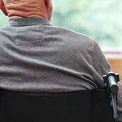 Thinking, back and senior man with disability in home, nostalgia and ...