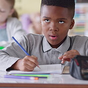 Boy, child and math test in classroom, counting fingers and ...