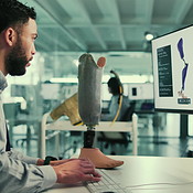 Leg prosthetic, screen or man on computer for research, inclusive ...
