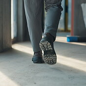 Construction, worker and legs of person walking for project ...