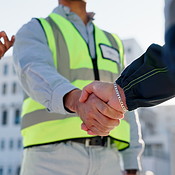 Handshake, partnership and construction team on site for building ...