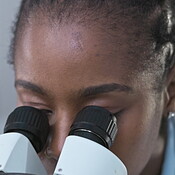 Scientist, study and black woman with microscope in lab for medical ...