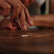 Drugs, addiction and hands of person with powder, card and dollar bill ...