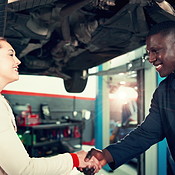 Handshake, mechanic and woman in garage, welcome and agreement for ...
