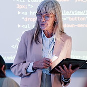 Coding, class and teacher at academy with mature woman, speaker and ...