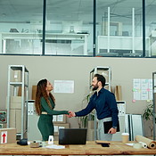 Man, woman and handshake with welcome for shipping, distribution and ...