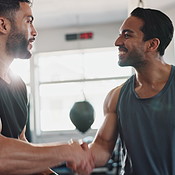 Workout, handshake and personal trainer with people in gym for training ...