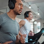 Man, fitness and running on treadmill with headphones for music ...