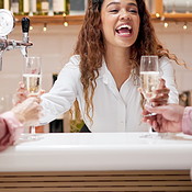 Bartender, woman and serving of drinks, smile and professional with ...