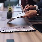 Hands, documents and business people in meeting for feedback, performance review and paperwork ...