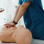 CPR, hands and doctor with student on medical simulation model for ...