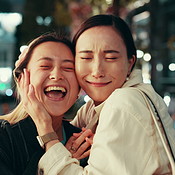 Women, friends and hug at night in city, happy and reunion with bonding ...