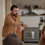 Acting, game or mime with man and friends in living room of home for ...