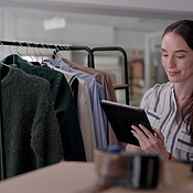 Woman, designer and tablet with clothing rack for check, stats and ...