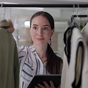 Woman, designer and tablet with clothing rack at shop, stats and ...