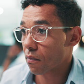 Programmer, face and man on technology for research, project and ...