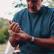 Senior, man and hands with joint inflammation on park bench for ...