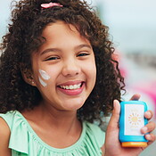 Face, smile and sunscreen with girl child outdoor at pool in garden of ...