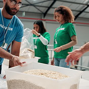 Charity, food drive and teamwork with volunteer people packing ...