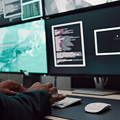 Computer screen, typing and video with person in CCTV control room for ...