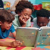 Reading, group and children with book in classroom for learning ...