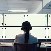 Computer, display and space for surveillance with woman in CCTV control ...