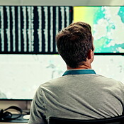 Man, computer and screen with satellite in control room, monitor ...