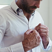 Man, dressing and ready with suit in bathroom for morning routine ...