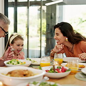 Laughing, food and health with family in dining room for nutrition ...
