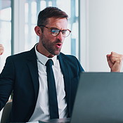 Businessman, celebration and fist pump with laptop in office ...
