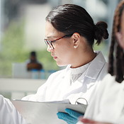 Scientist, women and research team in lab with documents, review and ...