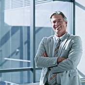 Arms crossed, proud and smile with business man at window of corporate ...