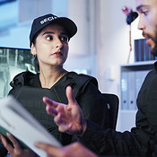 Computer screen, documents and tablet with people in surveillance ...