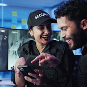 Computer screen, laughing and phone with people in CCTV control room ...