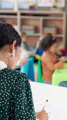 Marking, education and back of teacher in classroom with preschool ...
