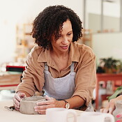 Women, instructor and molding clay for pottery of sculpture design ...
