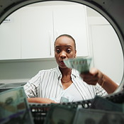 Washing machine, cash and black woman in crime for money laundering and ...