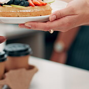 Hands, woman and serving food at cafe for client order, customer ...