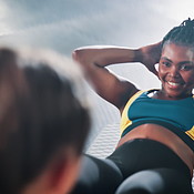 Personal trainer, sit ups and woman exercise with support for bodybuilding, strong muscle or six ...